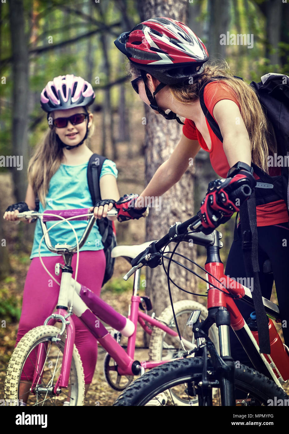 Bicyclist child ride on bicycle path in city. Children go down stairs ...