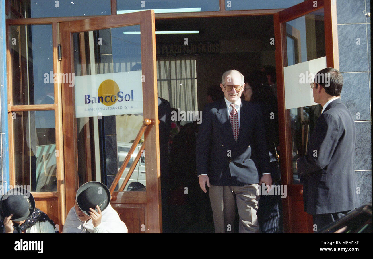 man walking out of building BancoSol Stock Photo - Alamy