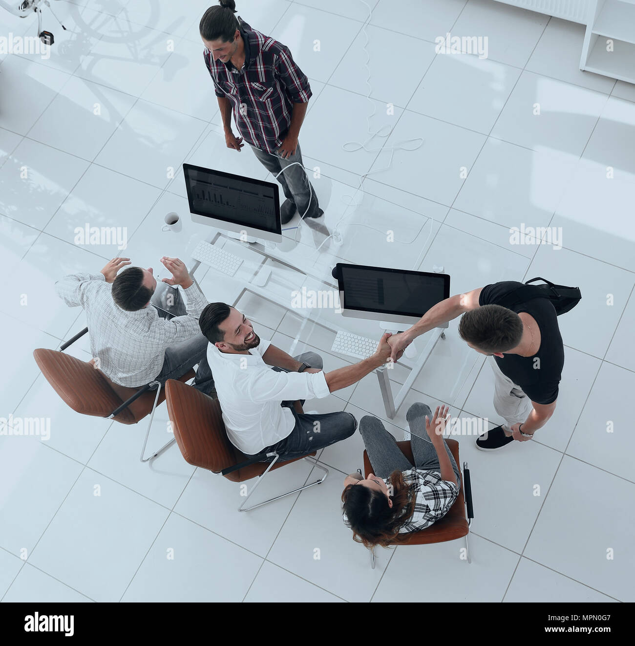 handshake of Agency staff at the Desk Stock Photo - Alamy