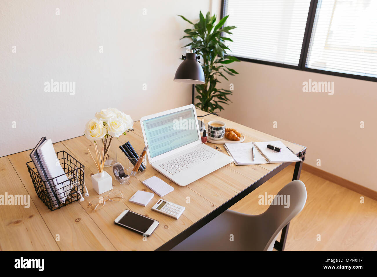 Laptop on desk in a bright and friendly office Stock Photo - Alamy