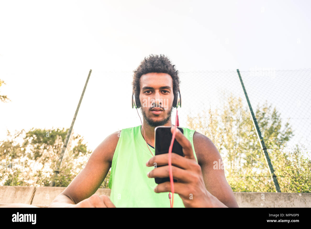 Basketball player listening music, smartphone and headphones Stock ...