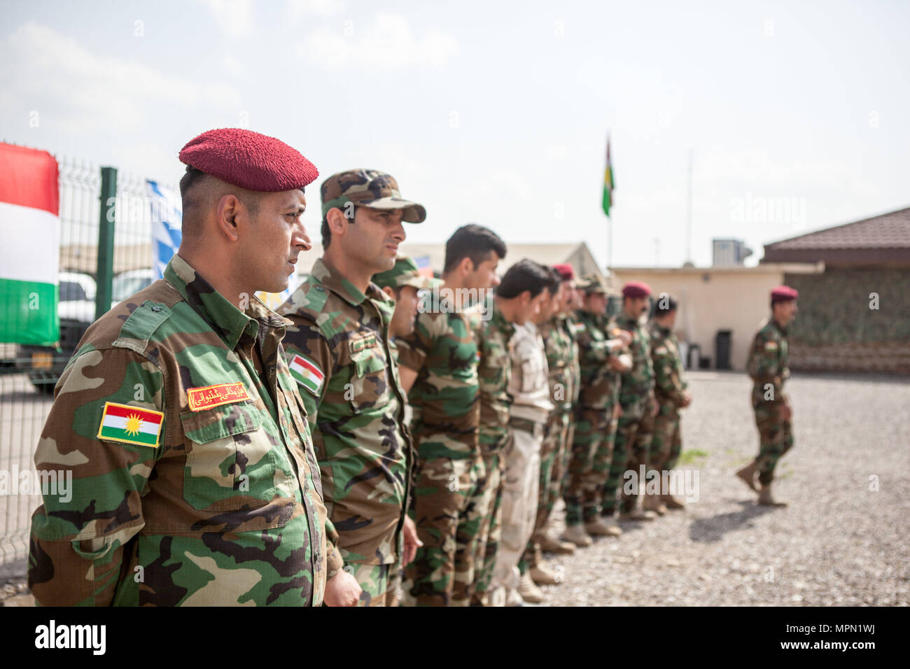 Peshmerga soldiers await the beginning of their graduation ceremony ...