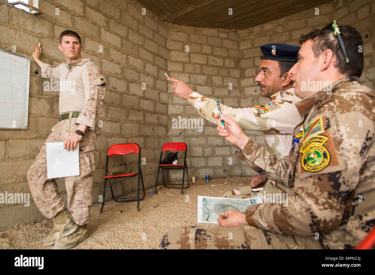 Iraqi security forces soldiers ask questions during a map reading class ...