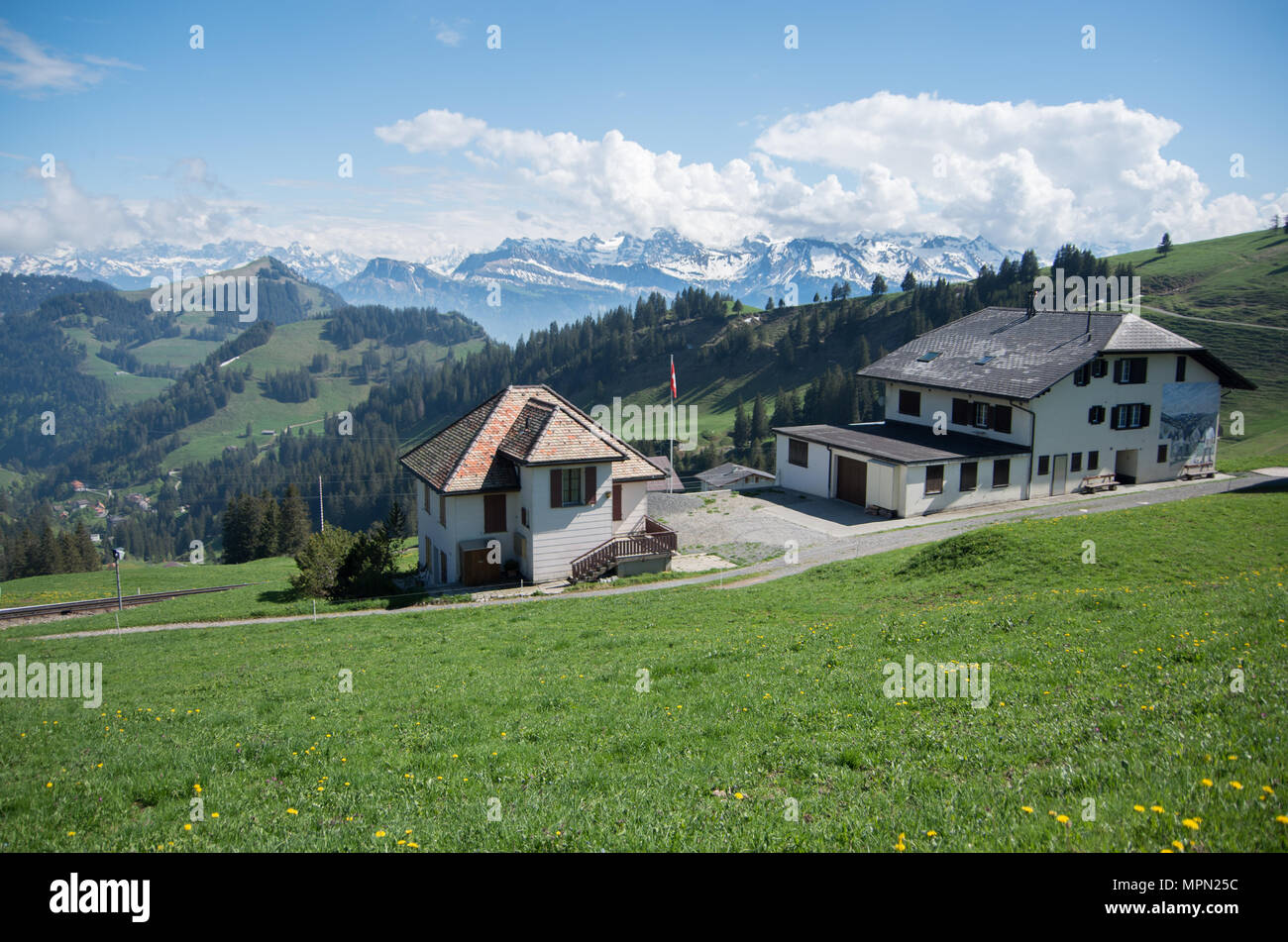 House and restaurant at the top of mount rigi surrounded by a green ...