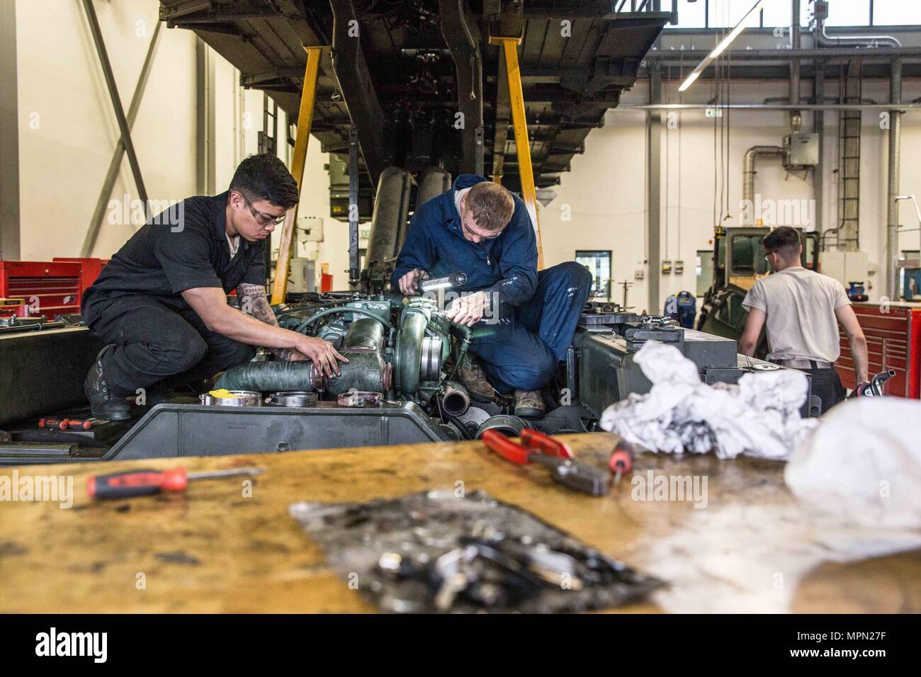 U.S. Airman First Class Devin Johnson (center), a vehicle mechanic with ...