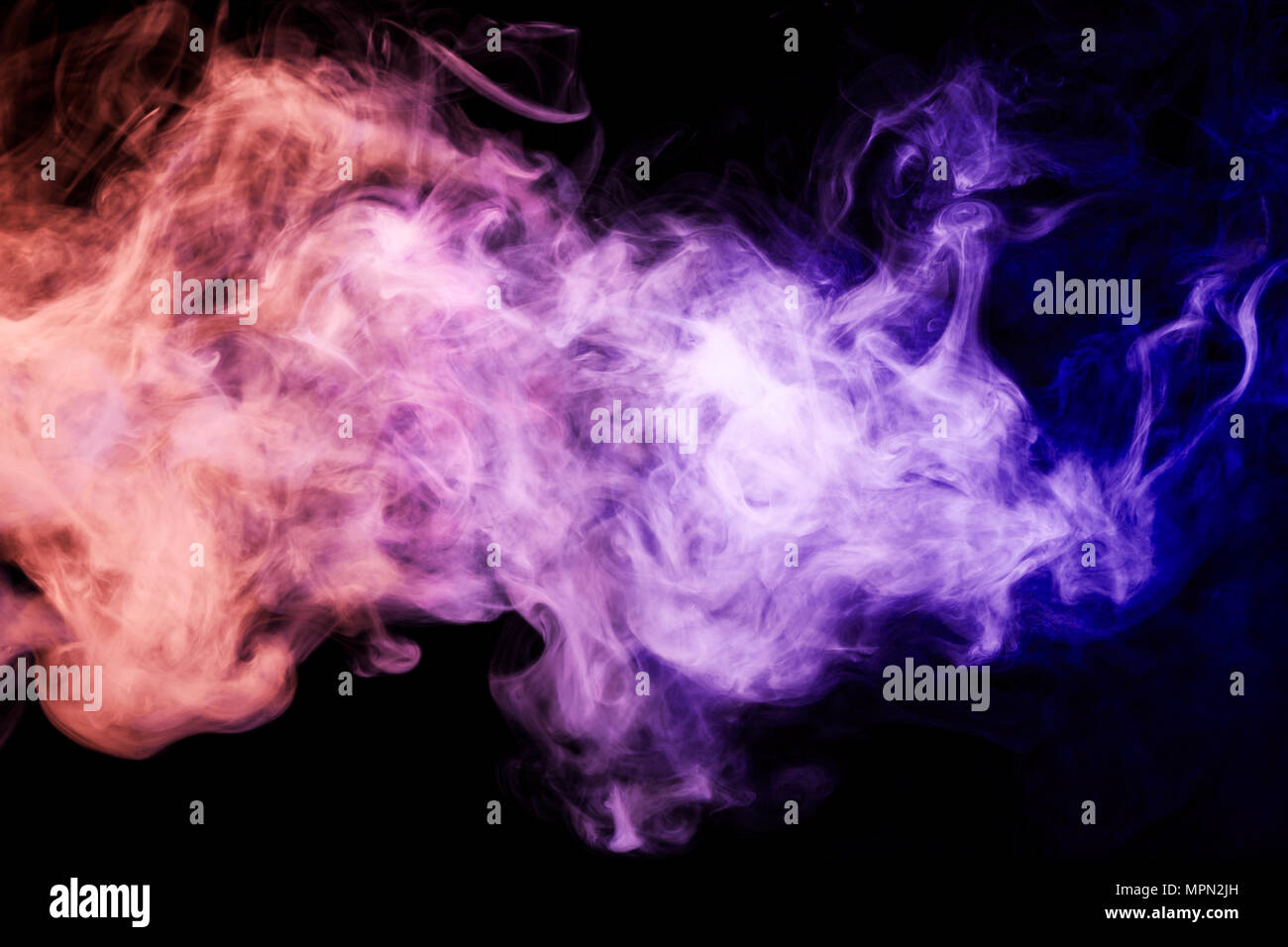 Colorful red and pink a smoke on a black isolated background ...