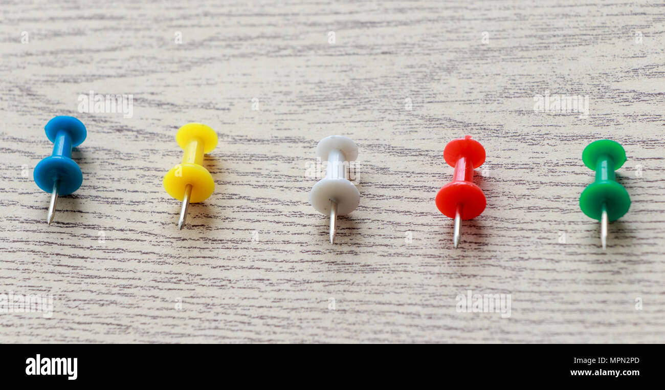Colorful pin put on wooden table top background Stock Photo - Alamy