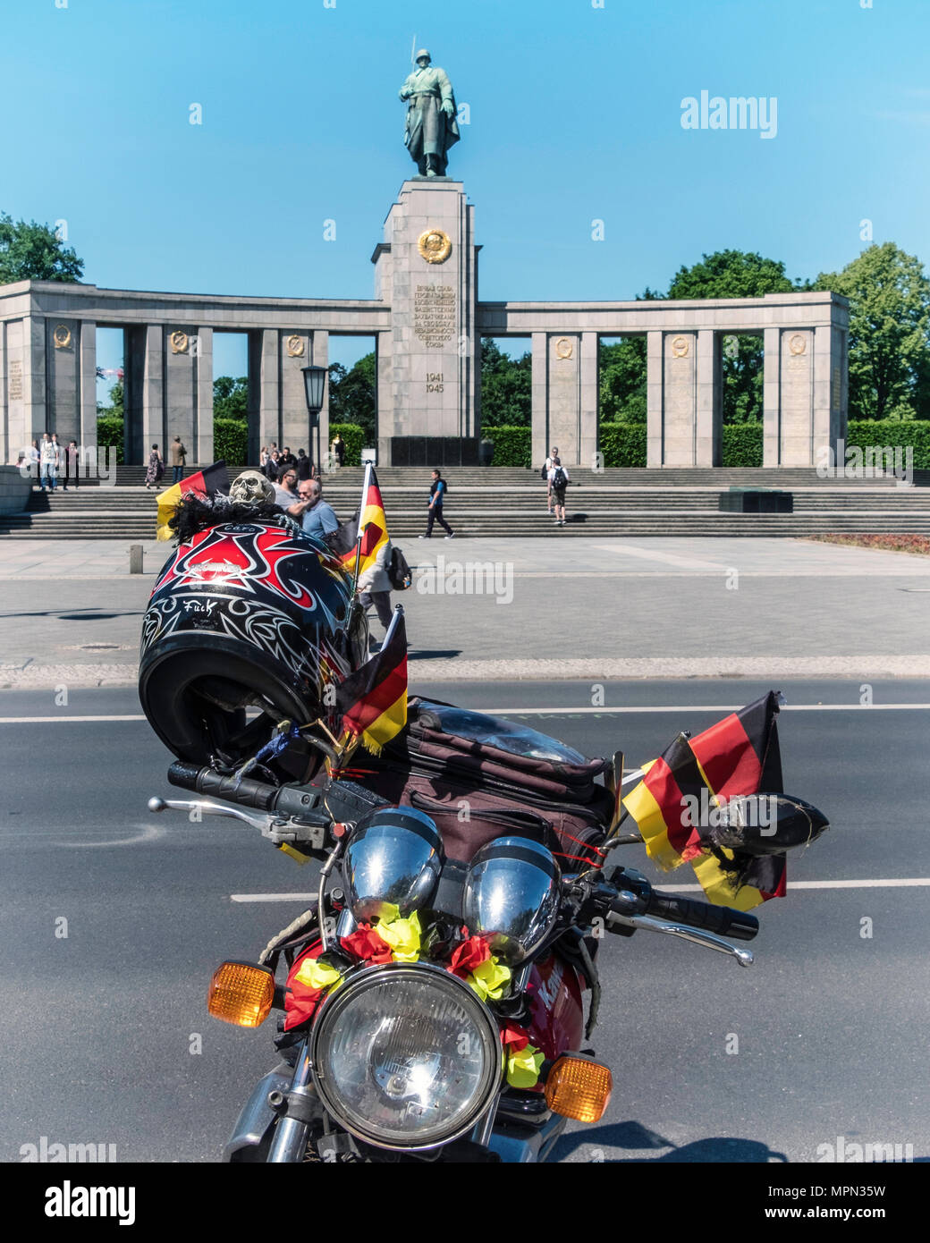 Berlin Mitte, Motor bike detail. Parked bike with German flags, helmet ...