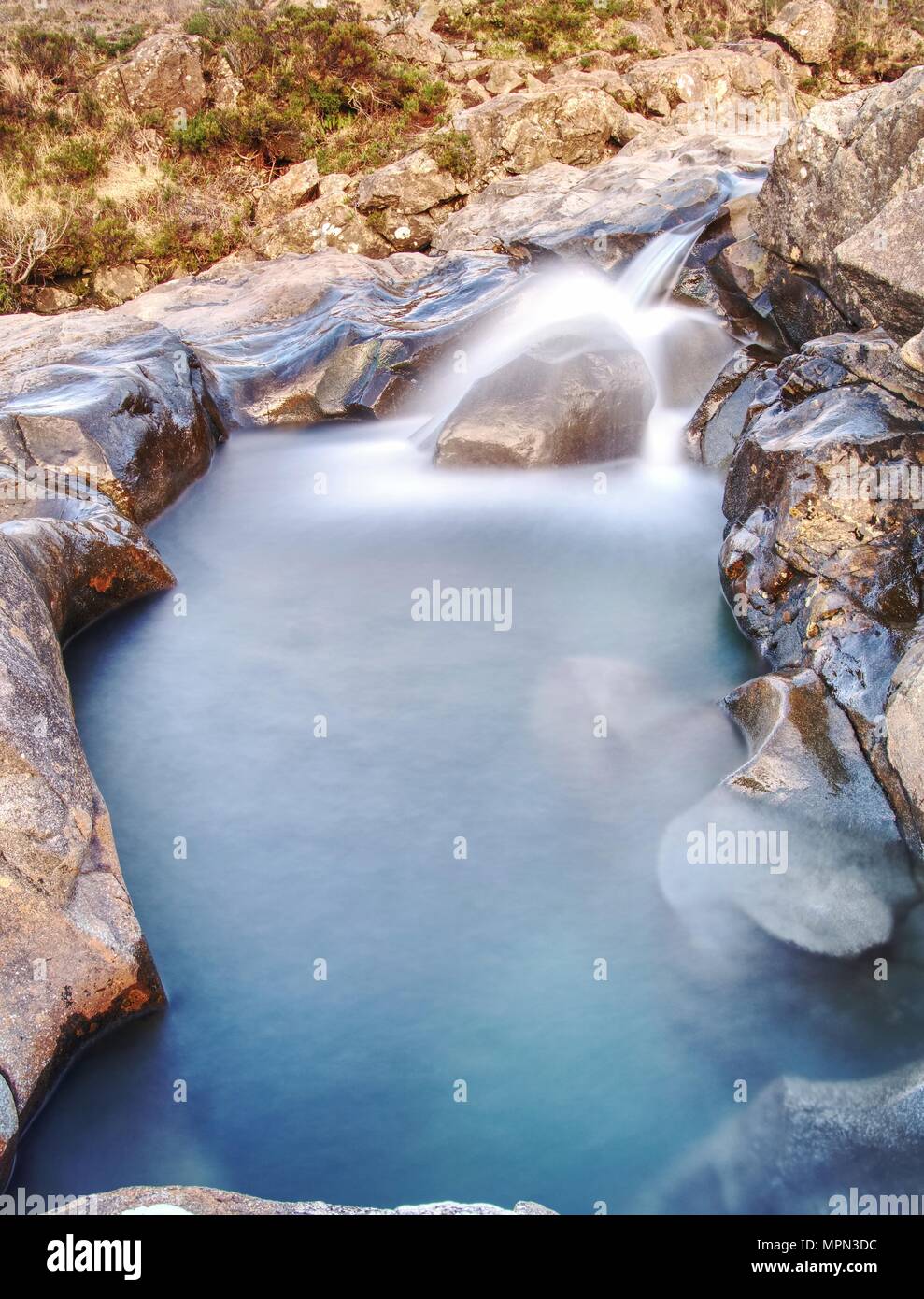 Multiple waterfalls, seemingly vibrant blue and green in color, with ...