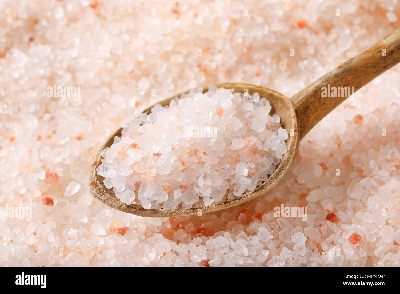 spoon of coarse grained salt on coarse grained salt background Stock ...
