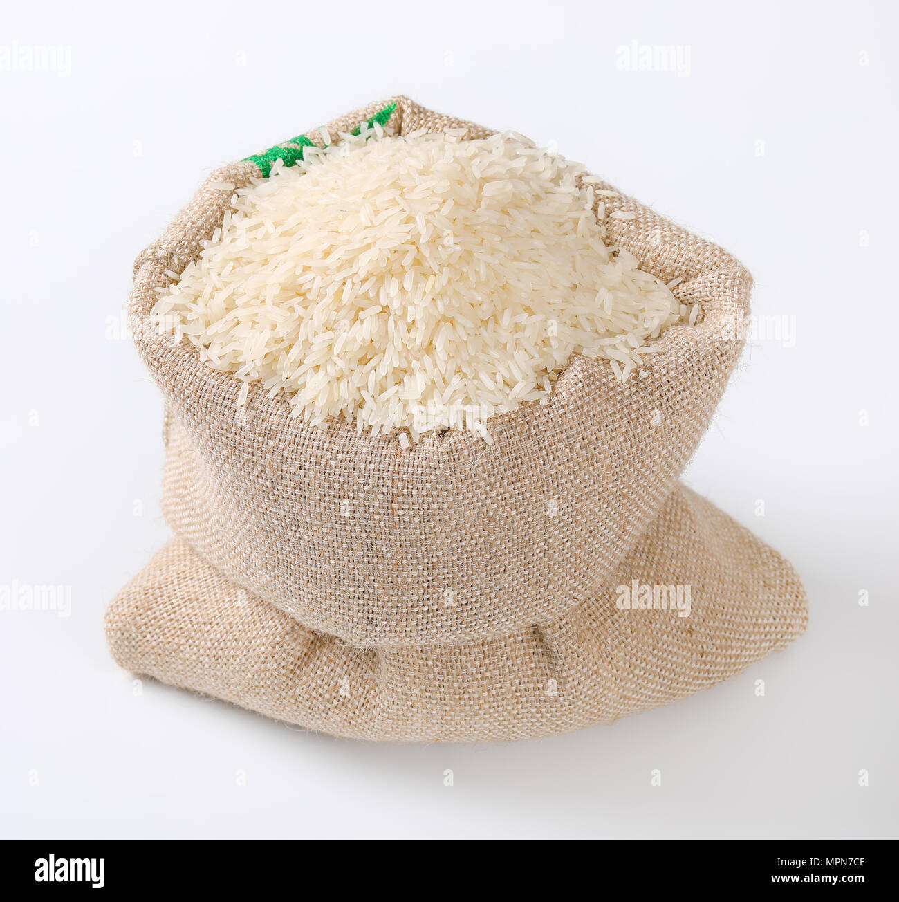 bag full of white long grained rice on white background Stock Photo - Alamy