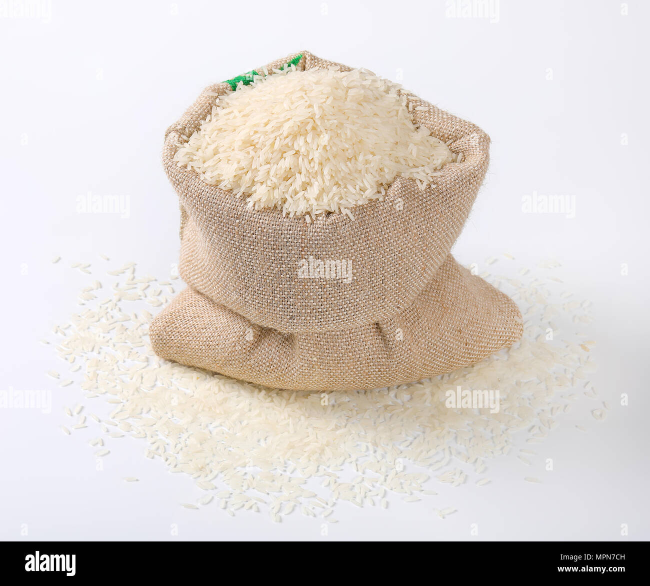 bag full of white long grained rice on white background Stock Photo - Alamy