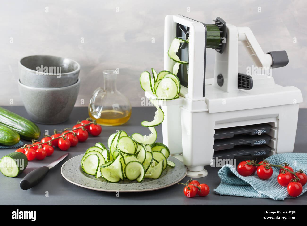 spiralizing cucumber vegetable with spiralizer Stock Photo - Alamy