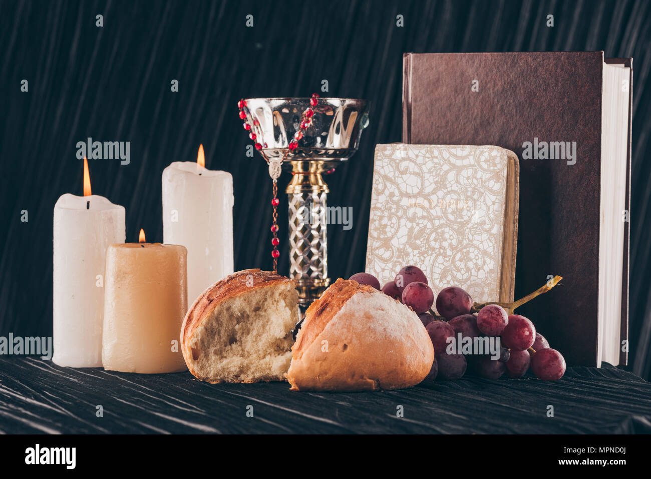 candles, chalice, holy bible, bread and grapes for Holy Communion Stock ...