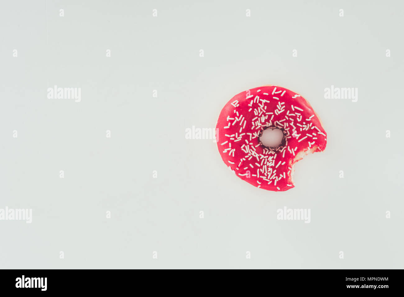 top view of bitten pink glazed doughnut isolated on white Stock Photo ...