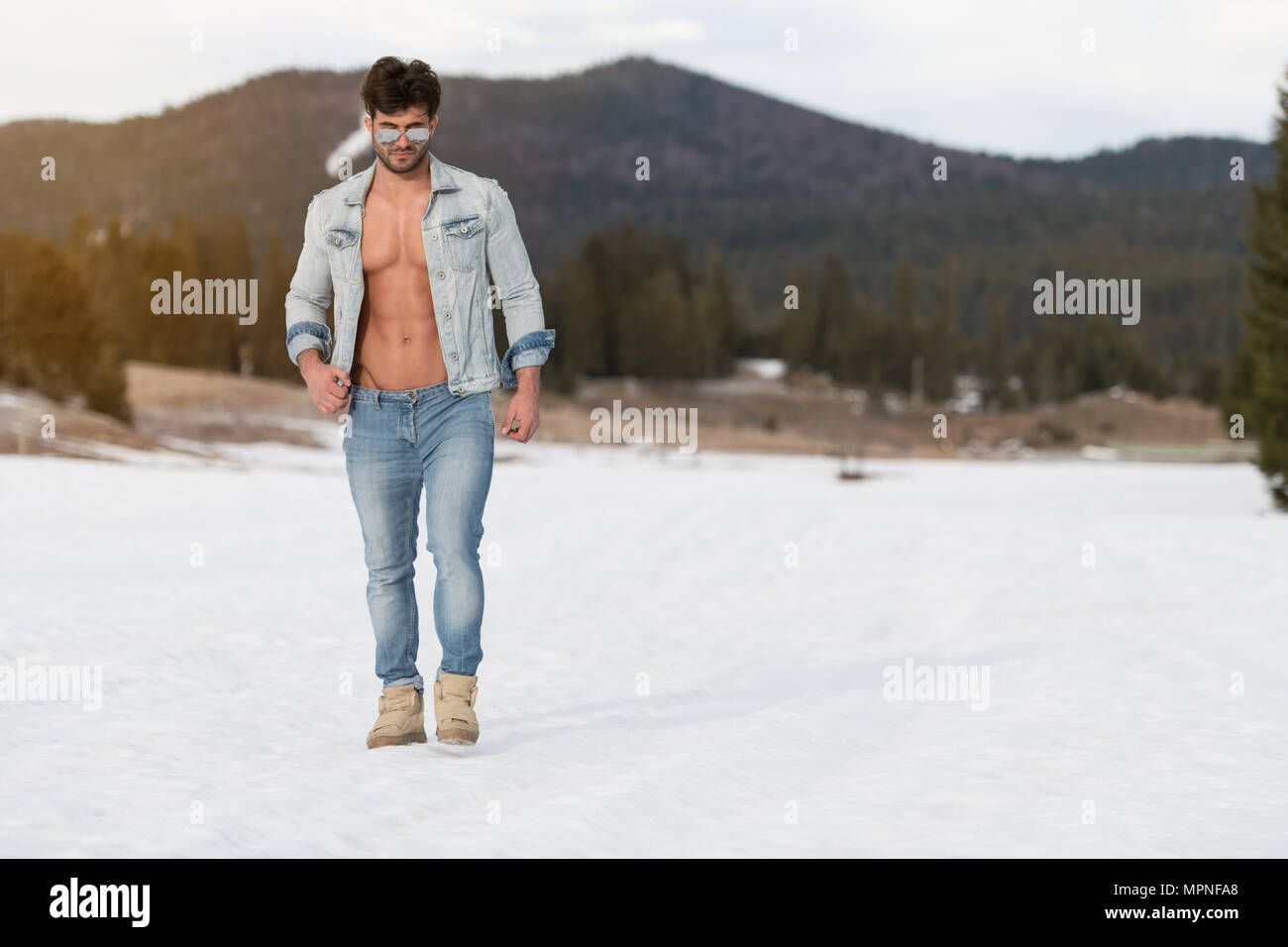 Healthy Young Man Standing Strong Flexing Muscles While Wearing Blue ...