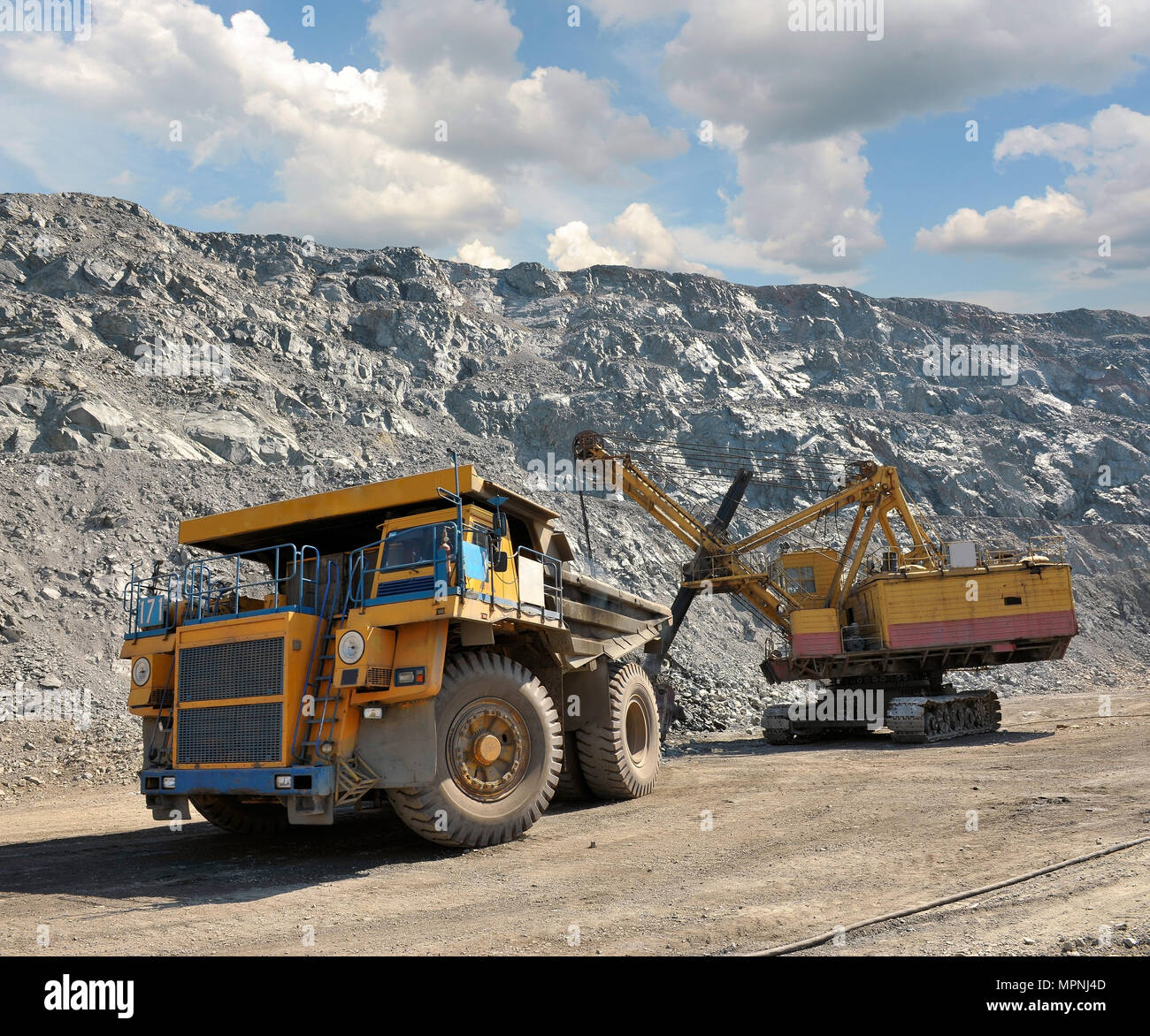 Loading of iron ore on very big dump-body truck Stock Photo - Alamy
