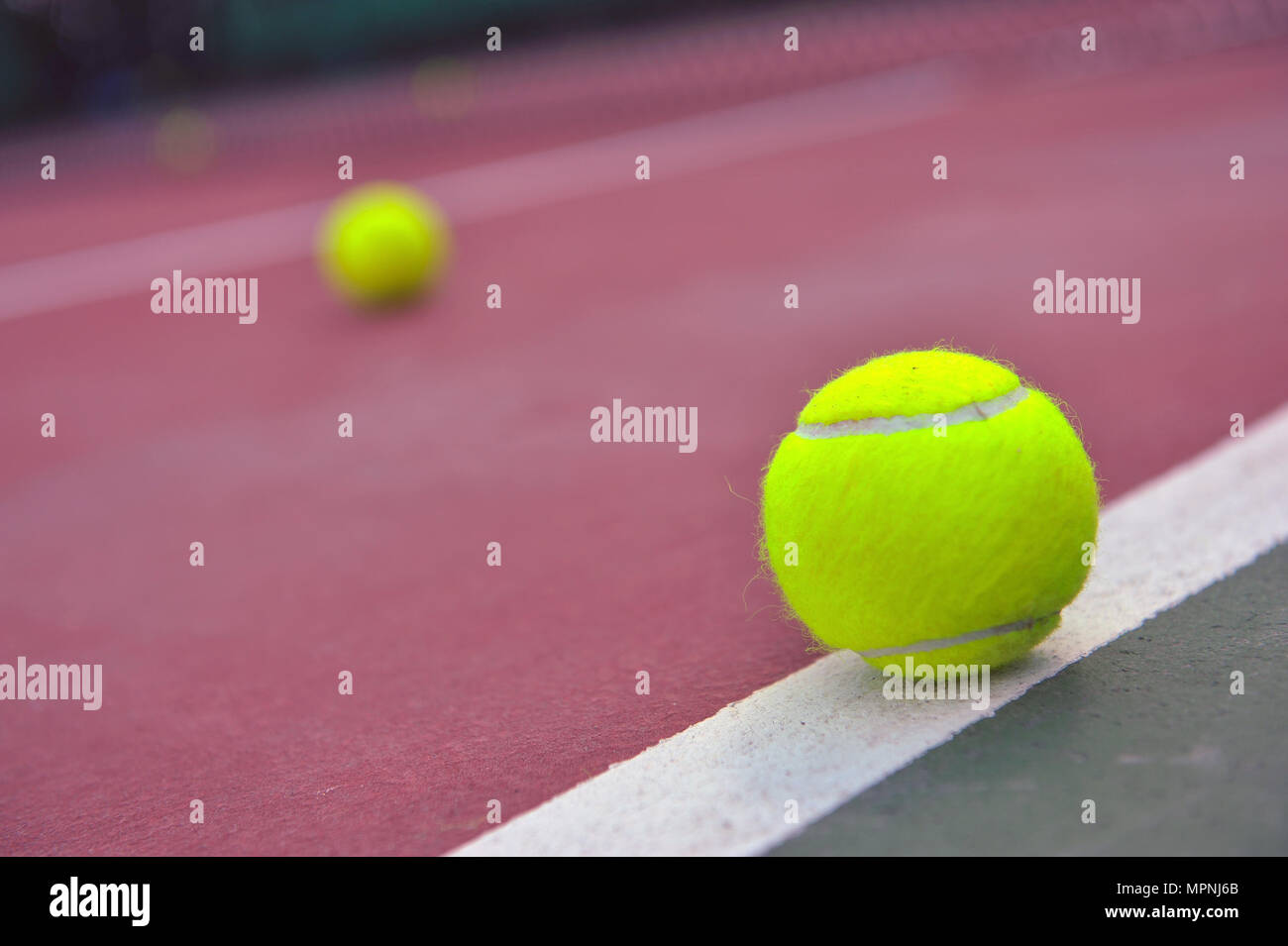 New Tennis Balls shot on a outdoor tennis court Stock Photo - Alamy