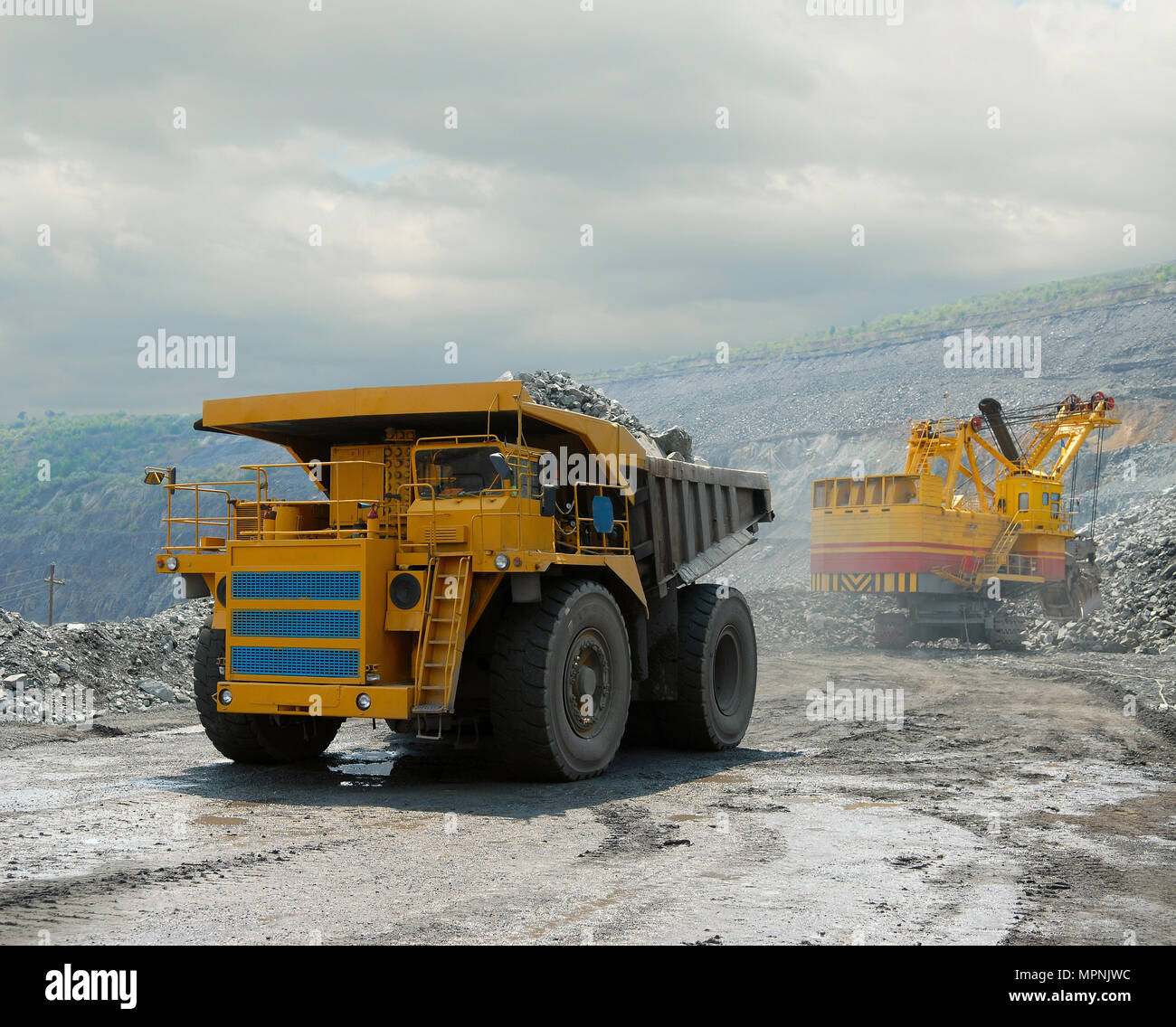 Loading of iron ore on very big dump-body truck Stock Photo - Alamy