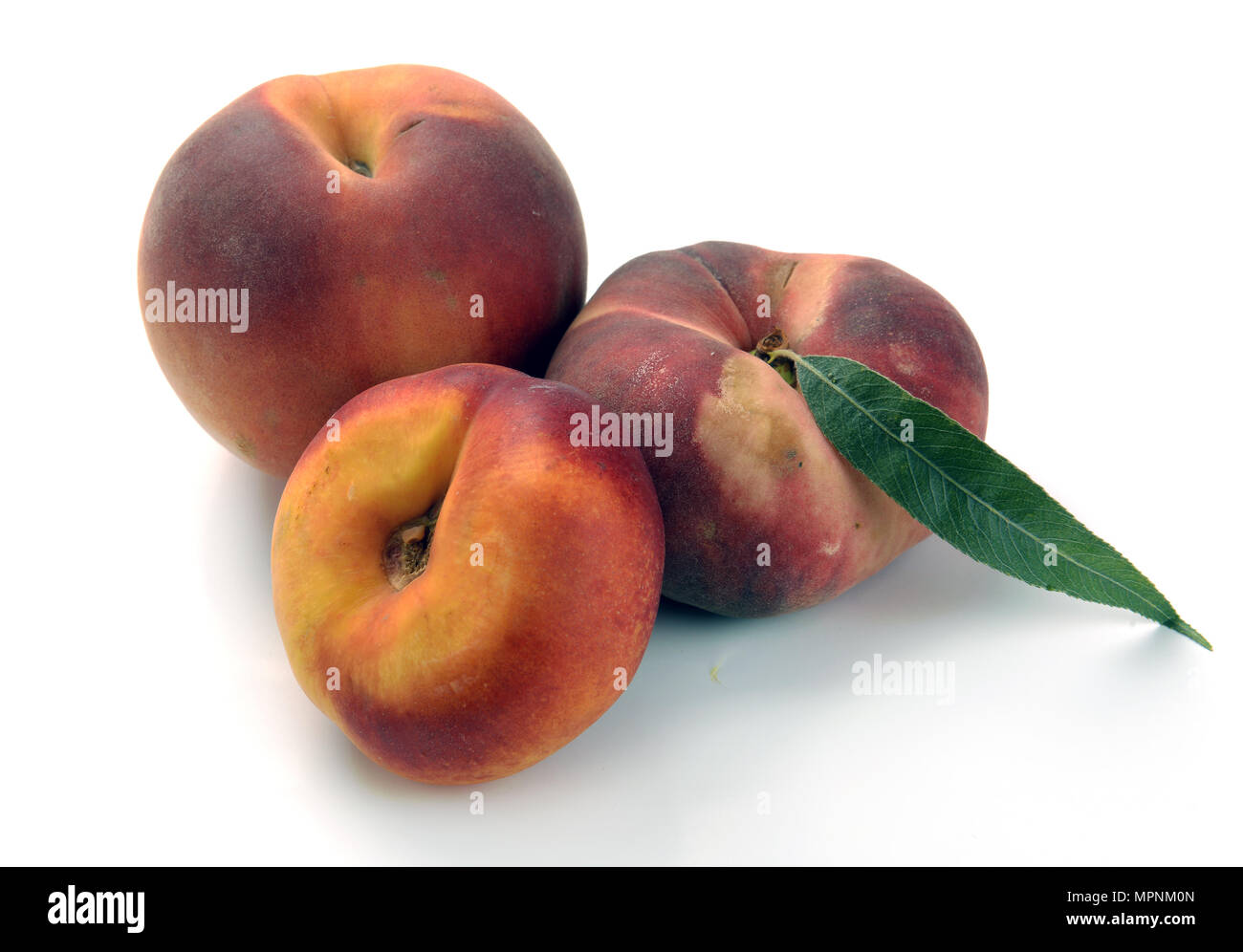 Chinese flat peaches nectarine on a white background Stock Photo - Alamy