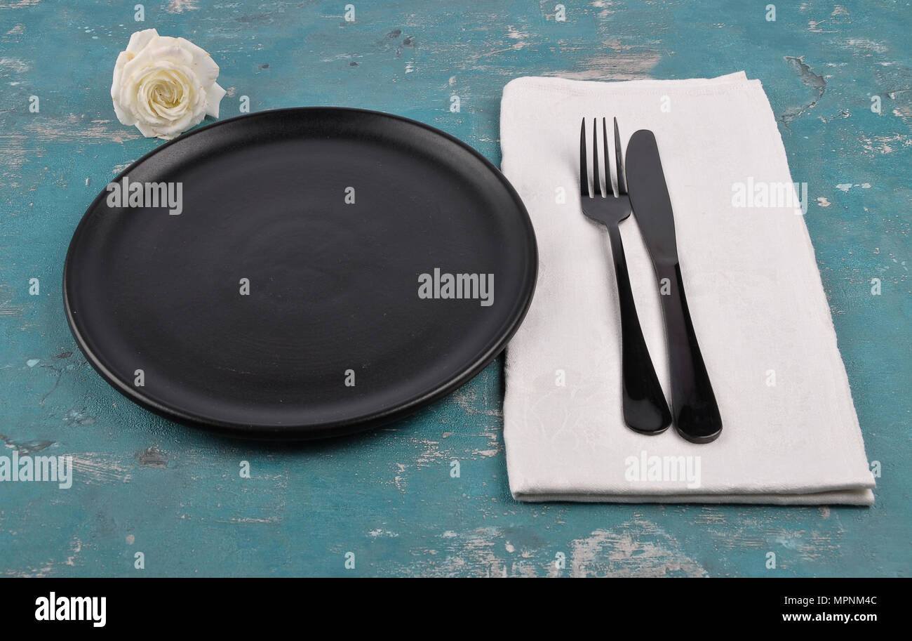 White rose and table setting on weathered concrete Stock Photo - Alamy