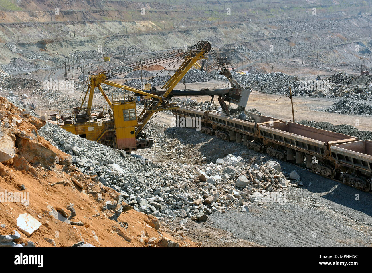Loading of iron ore on the train in career Stock Photo - Alamy