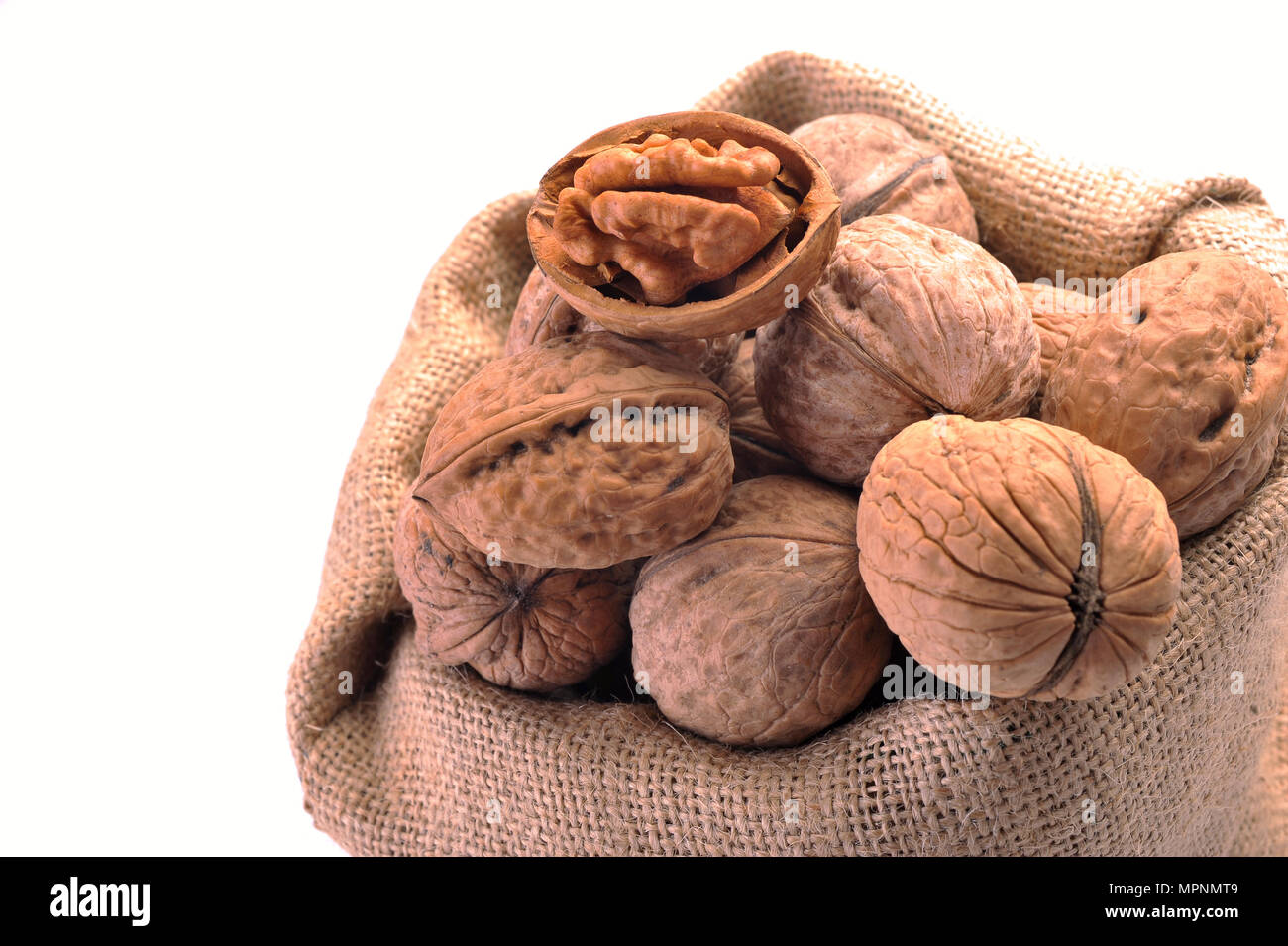 Walnuts in the tissue sac on a white background Stock Photo - Alamy