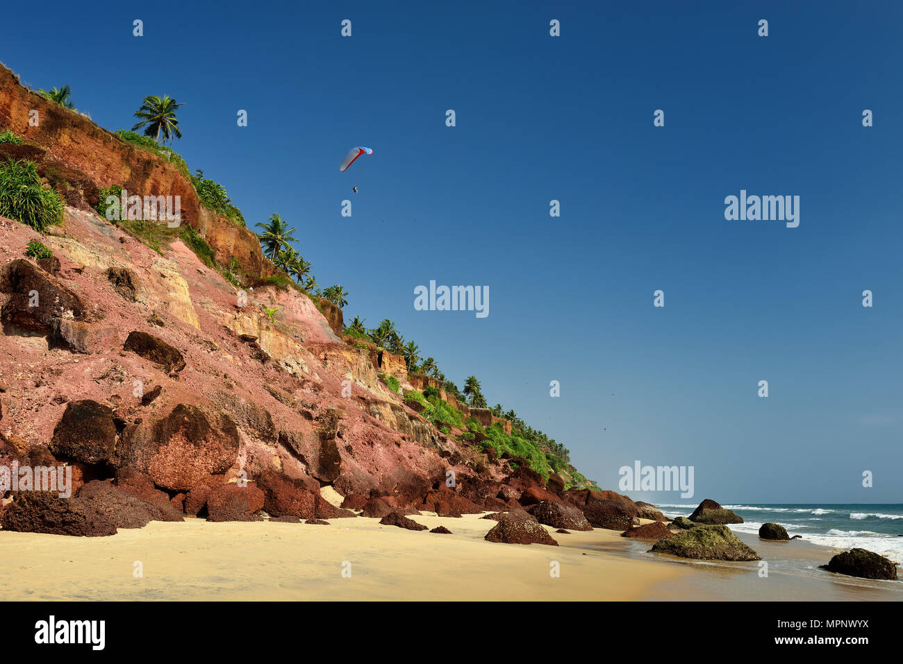 Exotic orange cliff beach in Varkala. Kerala. India Stock Photo - Alamy