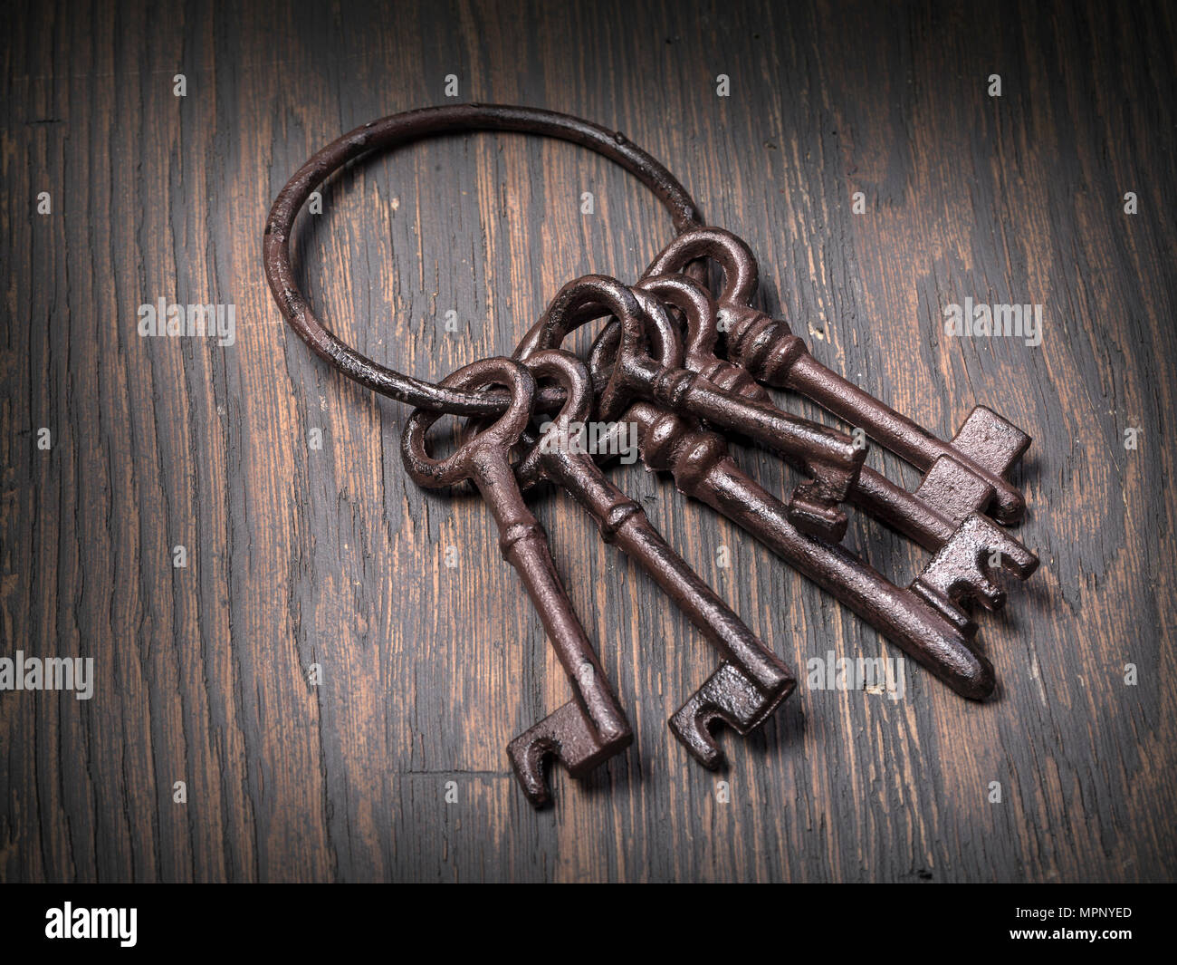 Old rusty keys on wooden background Stock Photo - Alamy