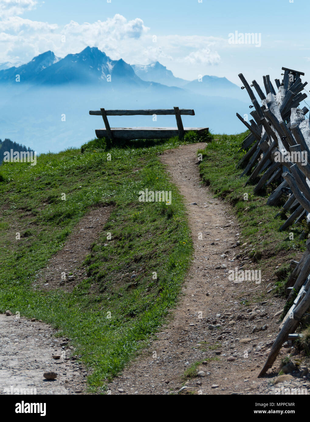 Wooden bench on mount rigi facing mount pilatus lead to by a dirt path ...