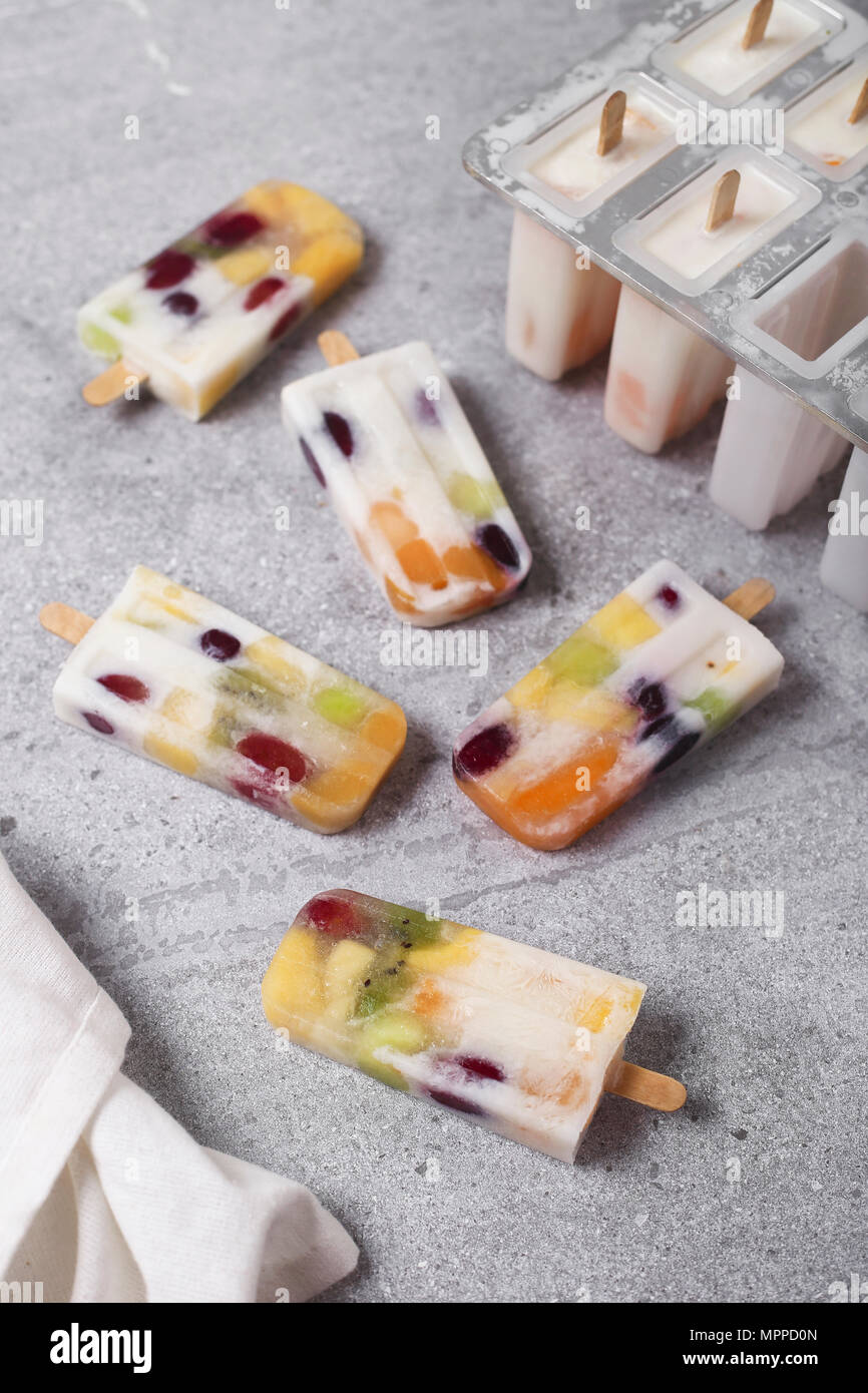 Homemade fruits and yogurt ice lollies on marble Stock Photo - Alamy