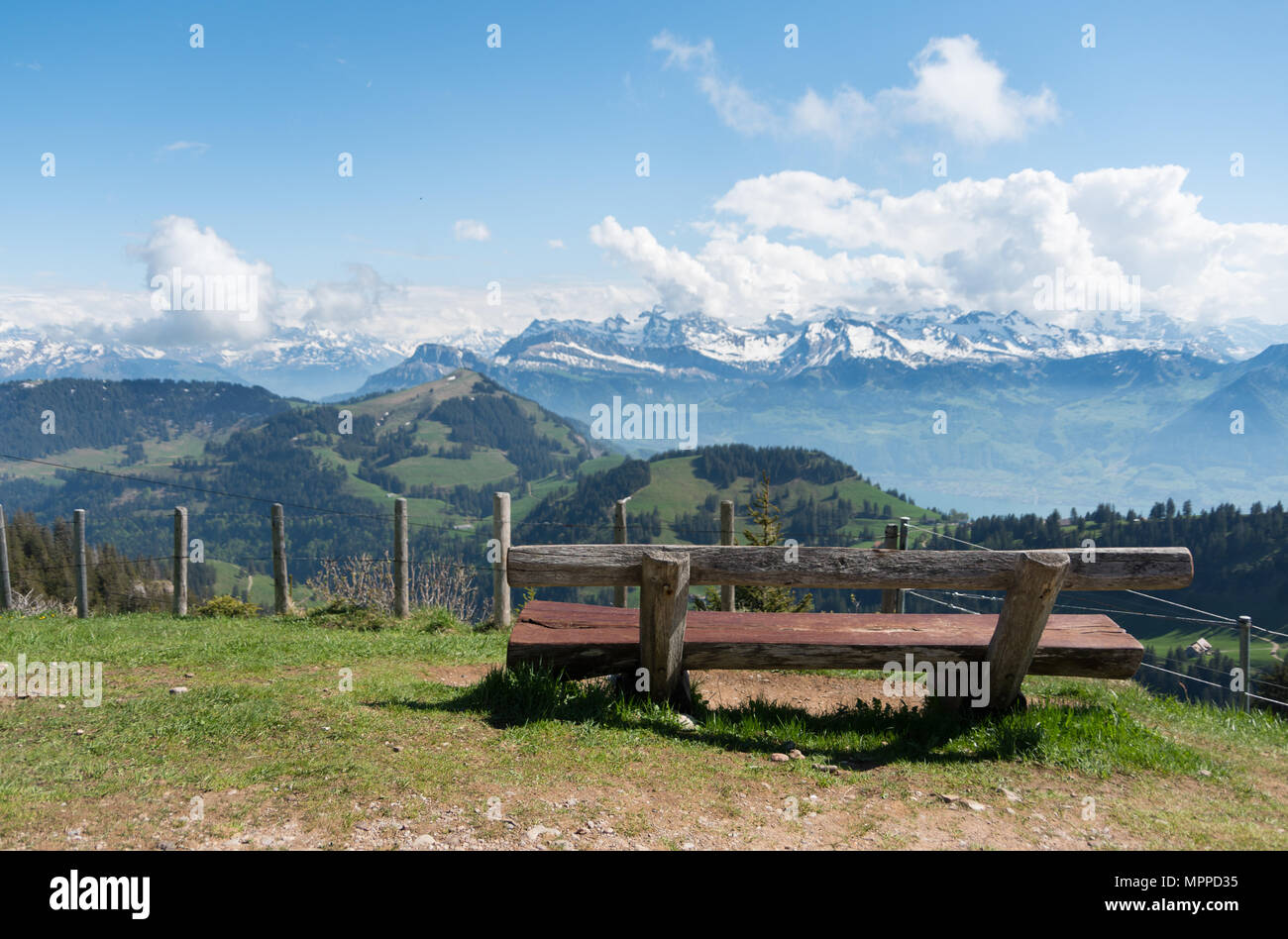 Brown wooden chair overlooking the swiss alps on mount rigi. Rest ...