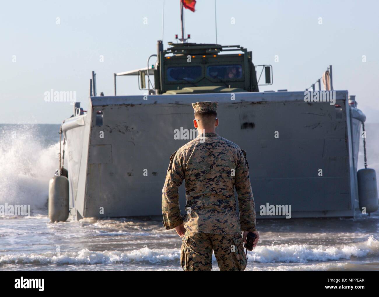 First Lt. James A. Teasdale supervises an Army Landing Craft Mechanized ...