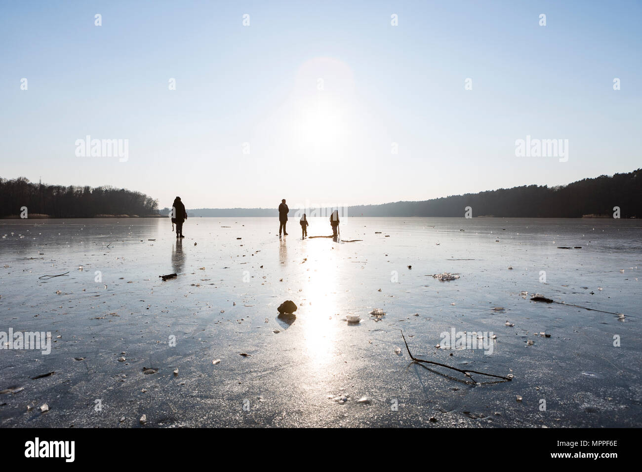 Frozen lake silhouettes people walking ice hi-res stock photography and ...