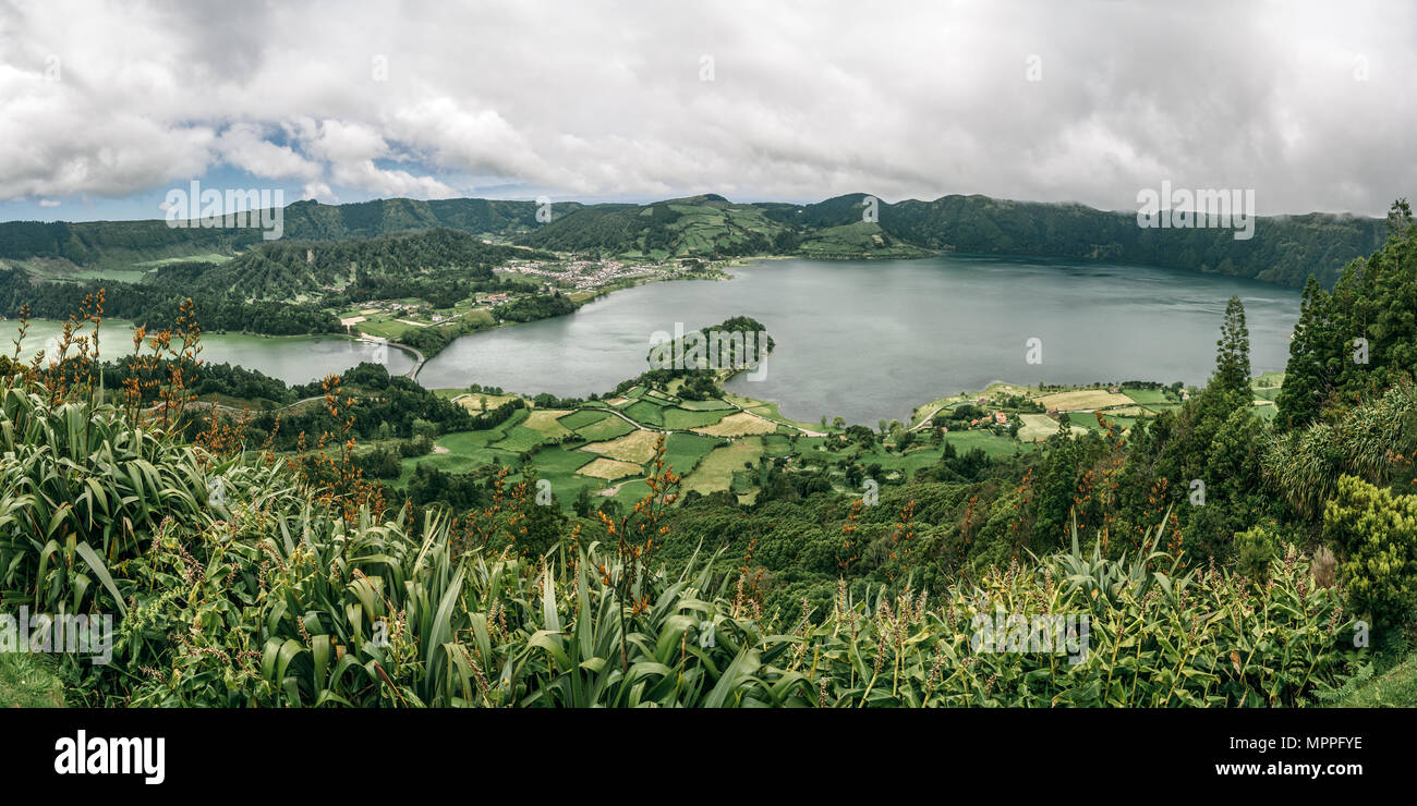 A panoramic top view of the Lagoa das Sete Cidades on a cloudy day at ...