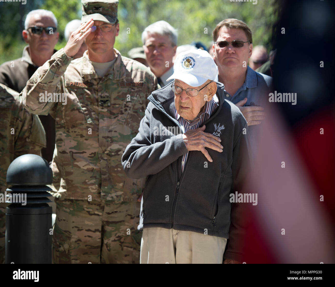Retired Lt. Col. Richard E. Cole stands for the national anthem at ...