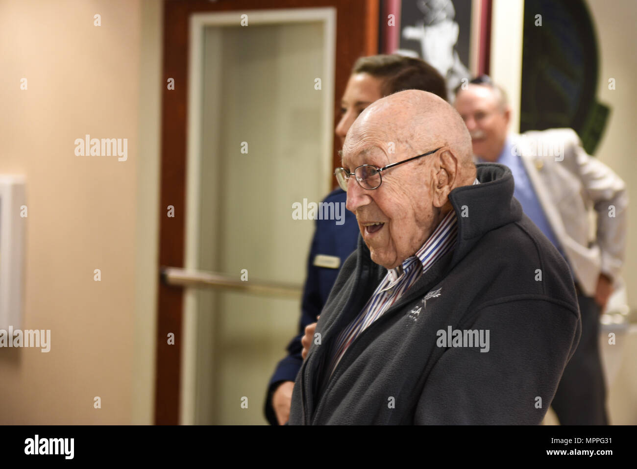 Retired Lt. Col. Richard E. Cole looks at current photos of crew ...