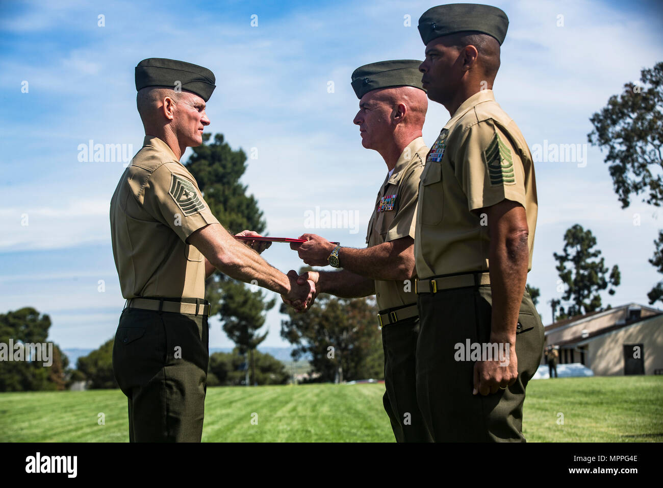U.S. Marine Sgt. Maj. Troy E. Black receives an award from Brig. Gen ...
