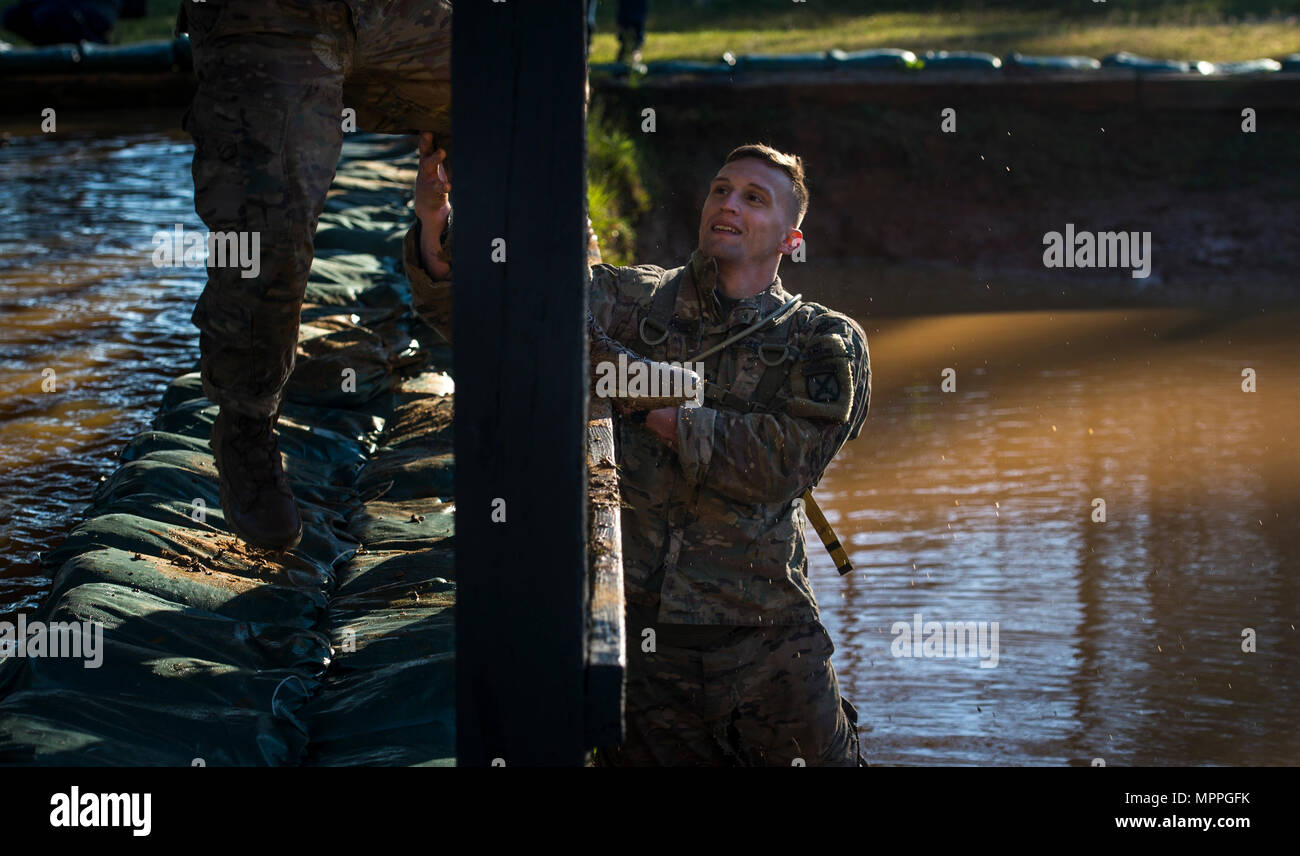 U.S. Army 1st Lt. Noah Currie, a 10th Mountain Division Ranger, assists ...