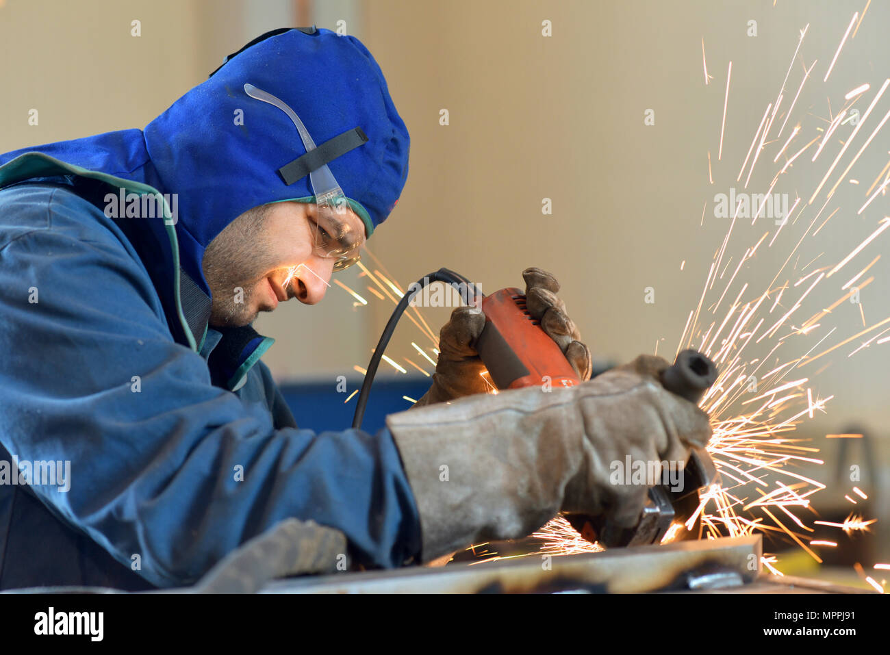 Male worker using grinder machine hi-res stock photography and images ...