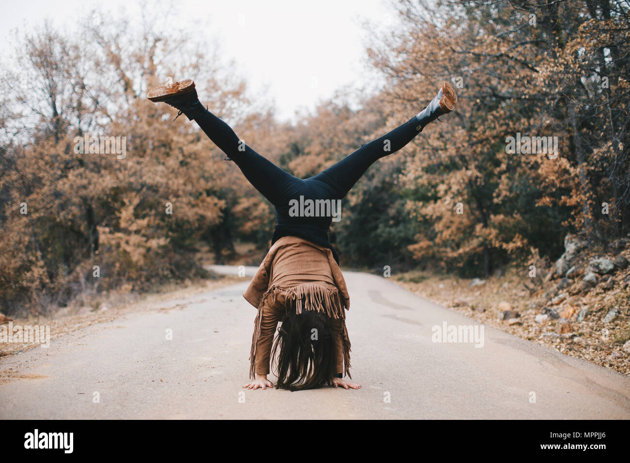 Back view of young woman doing handstand outdoors Stock Photo - Alamy
