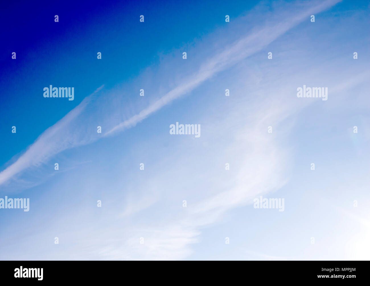 Clear blue sky with rare blurry white clouds Stock Photo - Alamy