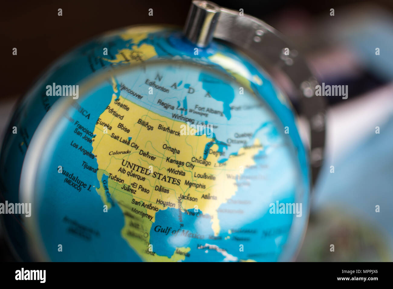 Globe and magnifying glass America Stock Photo - Alamy