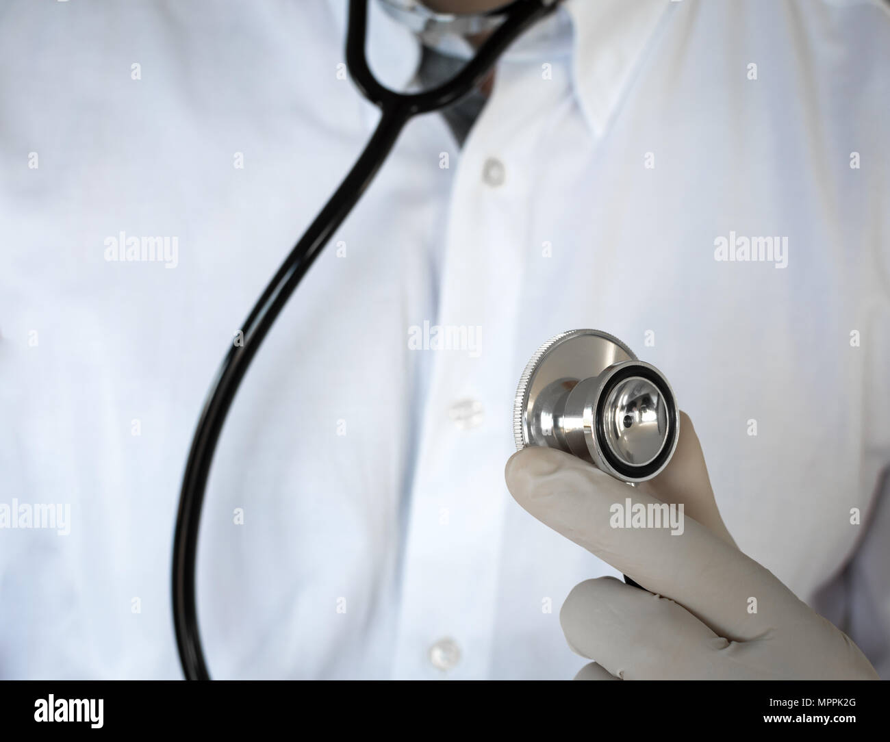 Doctor wearing his stetoscope Stock Photo - Alamy