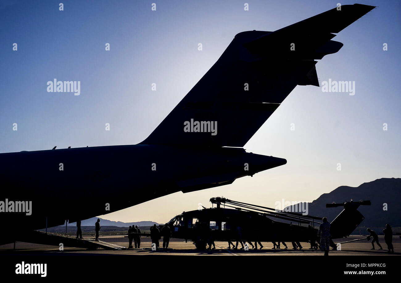 Airman push an HH-60 Pave Hawk assigned to the 34th Weapons Squadron ...