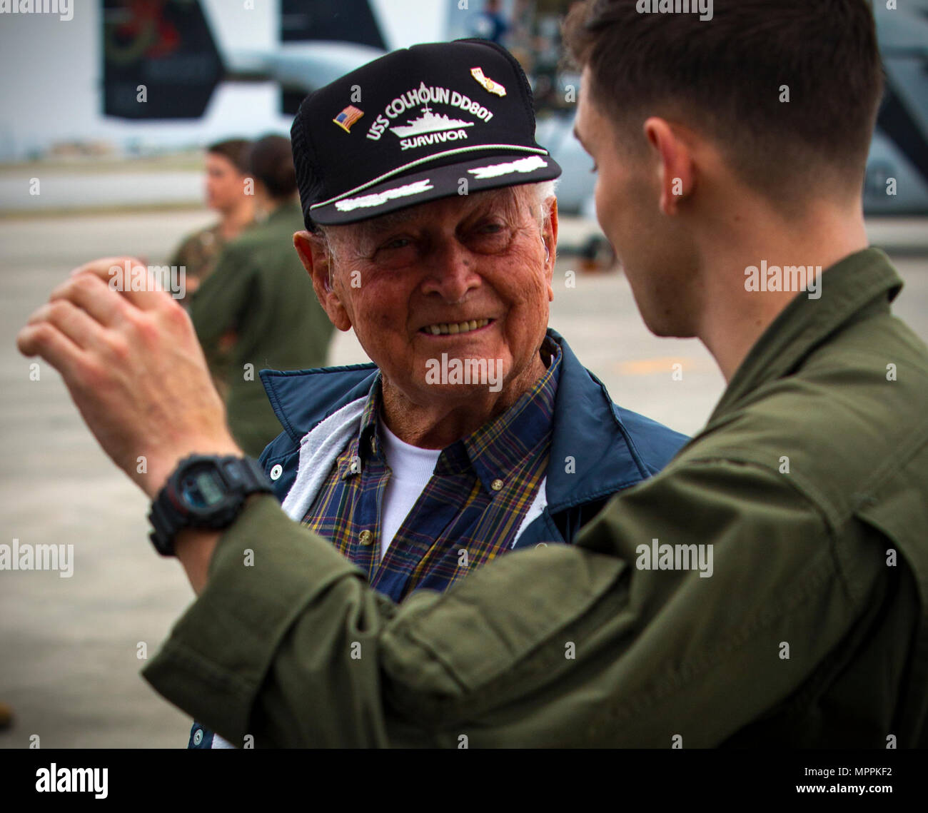 Capt. Joe Hamlin gives Donald Irwin, a U.S. Navy World War II veteran ...