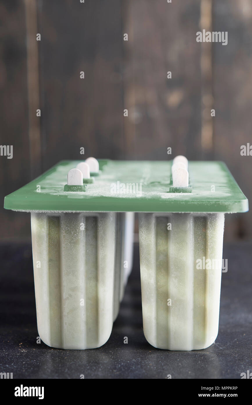 Homemade avocado lime popsicles in plastic box Stock Photo - Alamy