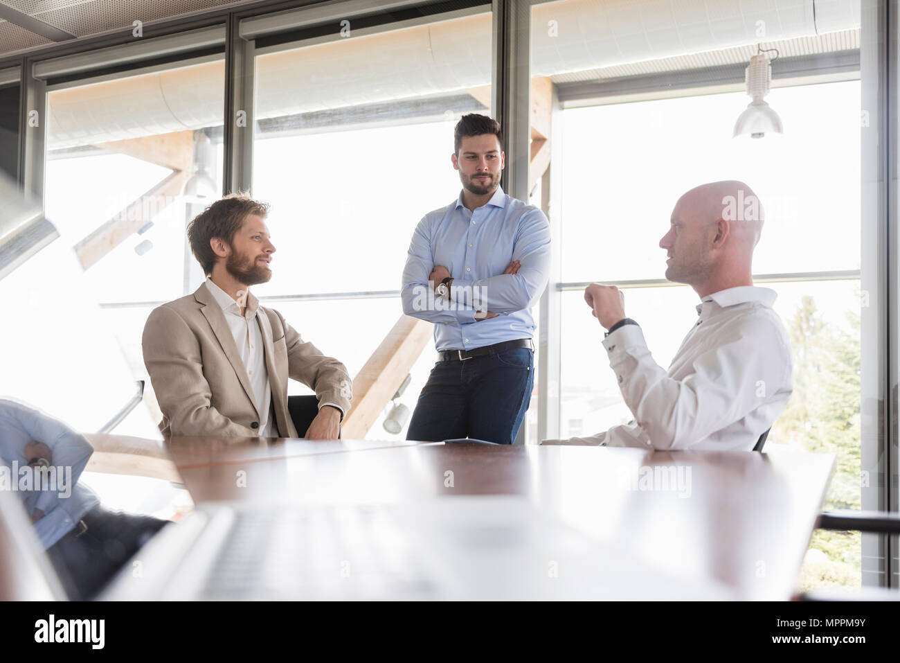 Three businessmen discussing in conference room Stock Photo - Alamy