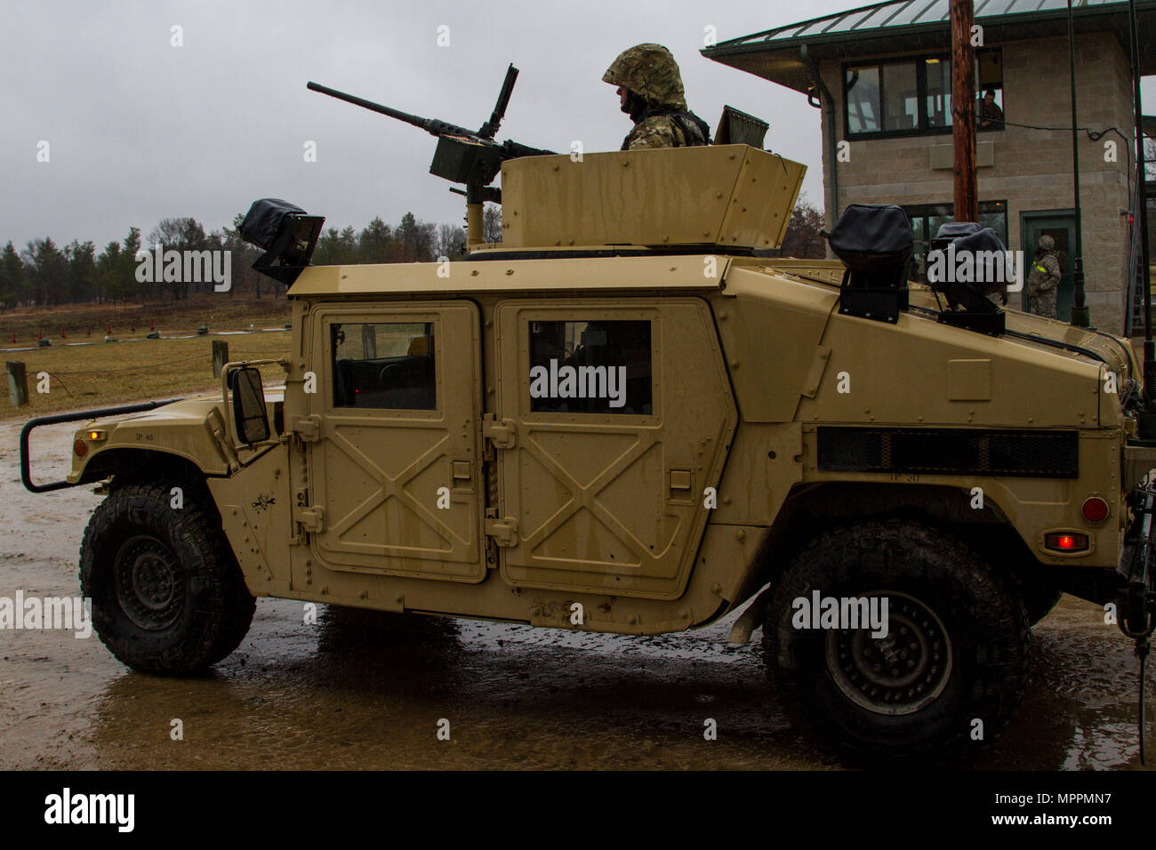 A tactical vehicle mounted with an M2 .50 caliber machine gun is staged ...