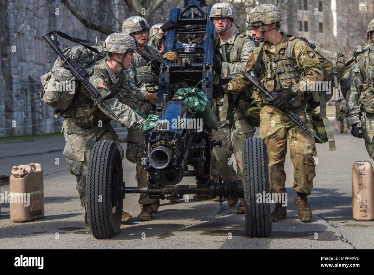 U.S. Army cadets move a howitzer, water cans and ammo boxes as part of ...